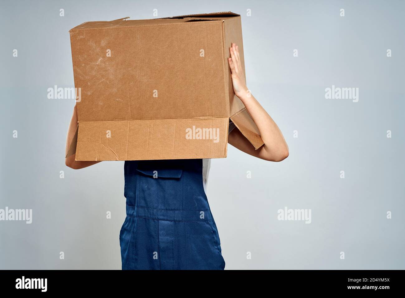 Woman in working uniform box packing service lifestyle Stock Photo - Alamy