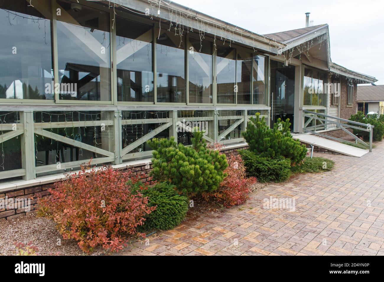 modern restaurant with green lawn, tile path and landscape design with ...