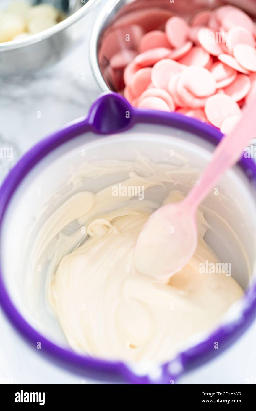Melting chocolate chips in candy melting pot Stock Photo - Alamy