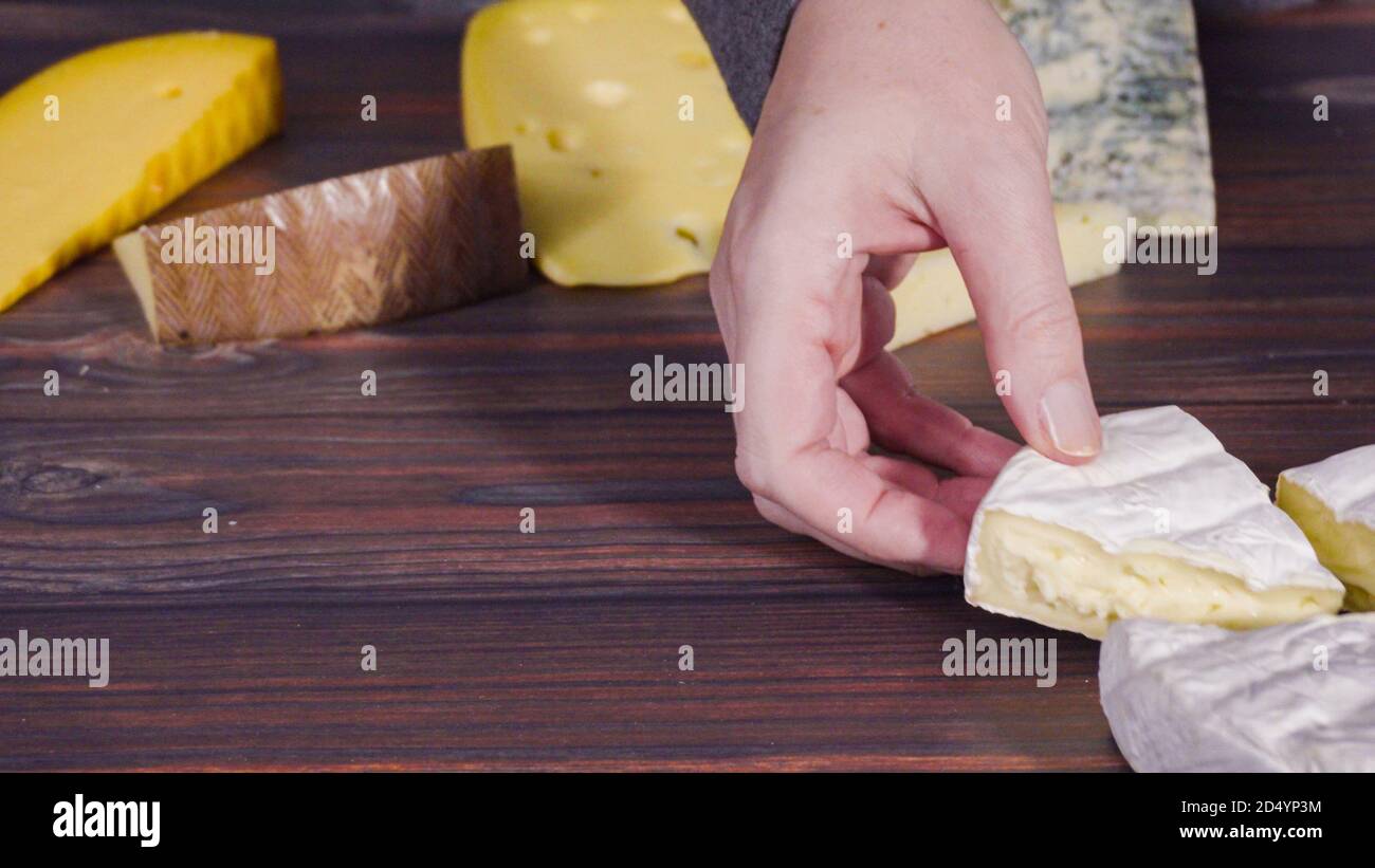 Large wedges of gourmet cheese on a rustic wood background Stock Photo ...