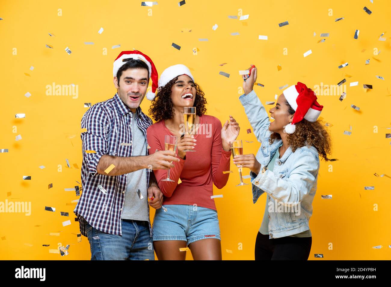 Group of three happy diverse friends celebrating Christmas drinking ...