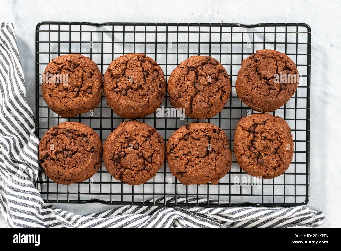 Flat lay. Freshly baked double chocolate chip cookies on a cooling rack ...