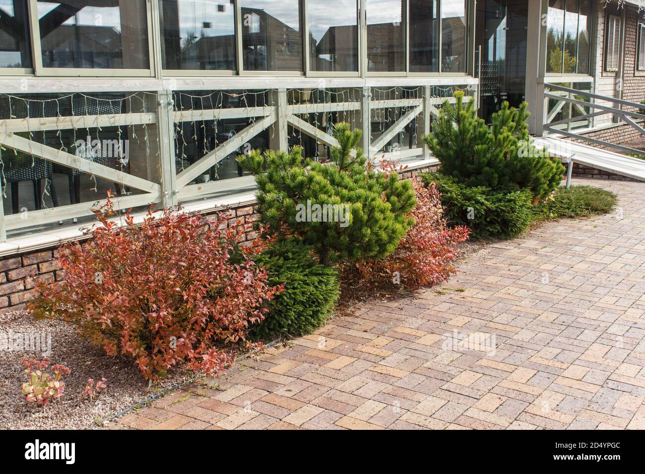 modern restaurant with green lawn, tile path and landscape design with ...