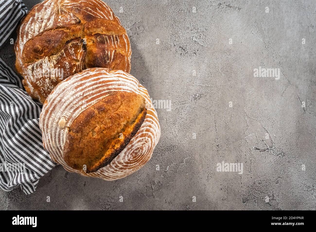 Flat lay. Freshly baked loaf of a wheat sourdough bread with marks from ...