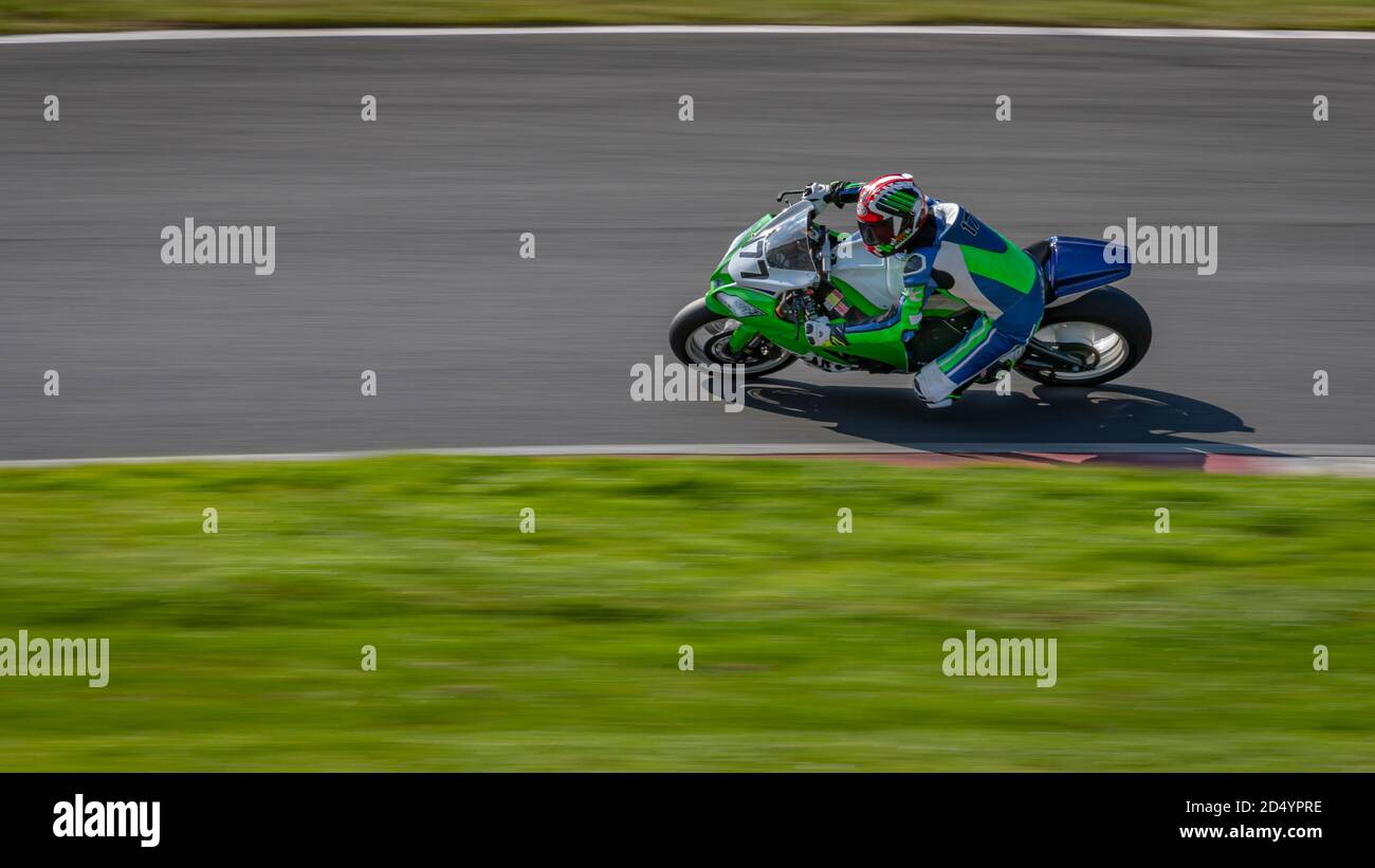 A panning shot of a racing bike cornering on a track Stock Photo - Alamy