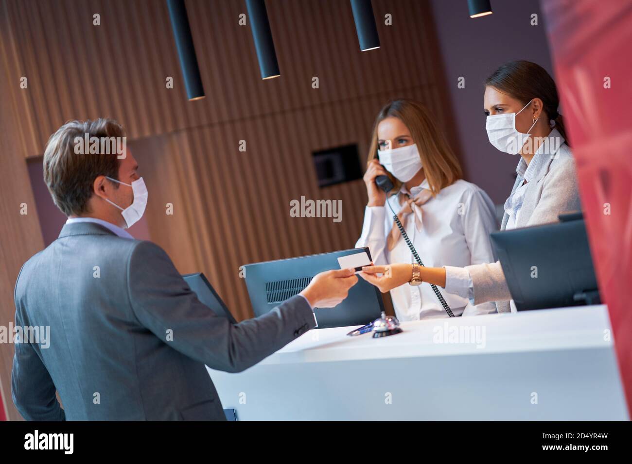 Hotel manager in mask, lobby hi-res stock photography and images - Alamy