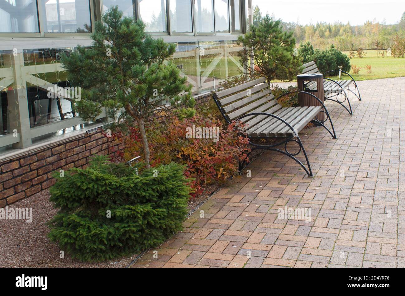 modern restaurant with green lawn, tile path and landscape design with ...