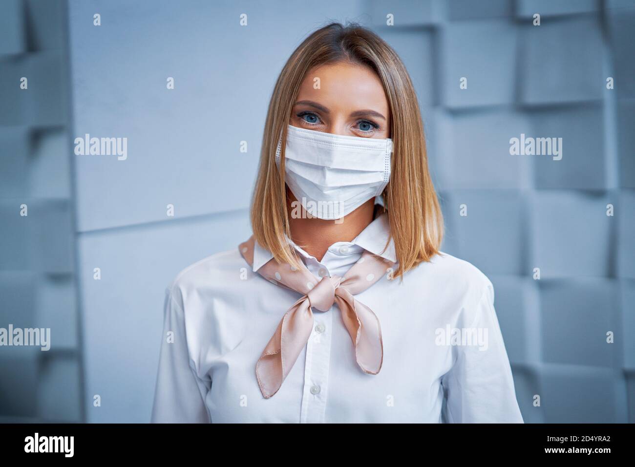 Female receptionist wearing face mask Stock Photo - Alamy