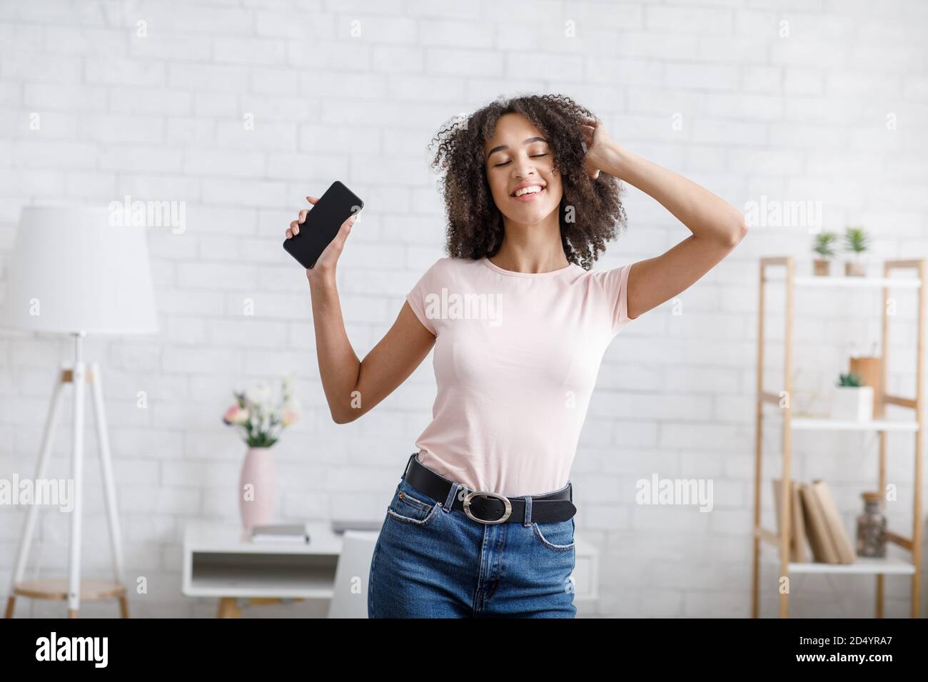 Home alone and fun at free time. Smiling millennial african american ...