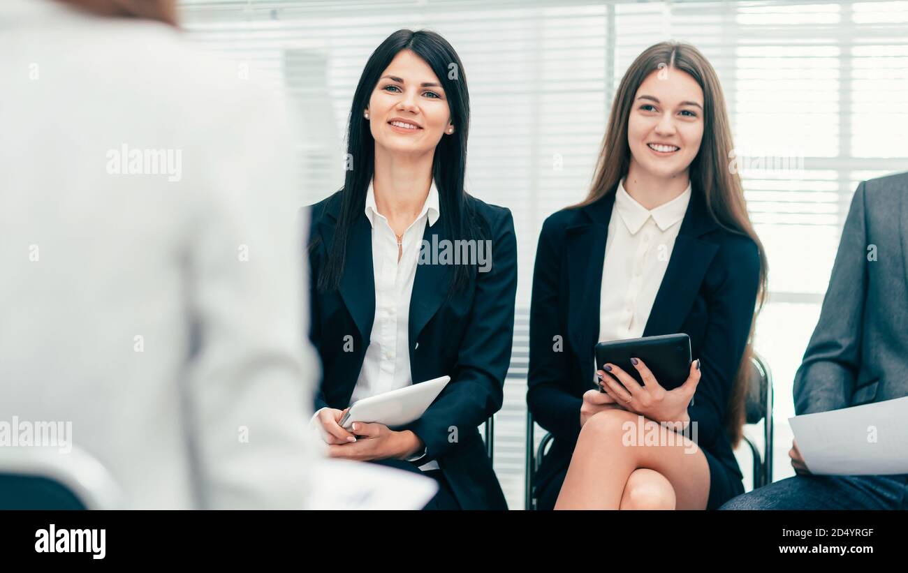 close up. employees asking questions at a work meeting Stock Photo - Alamy