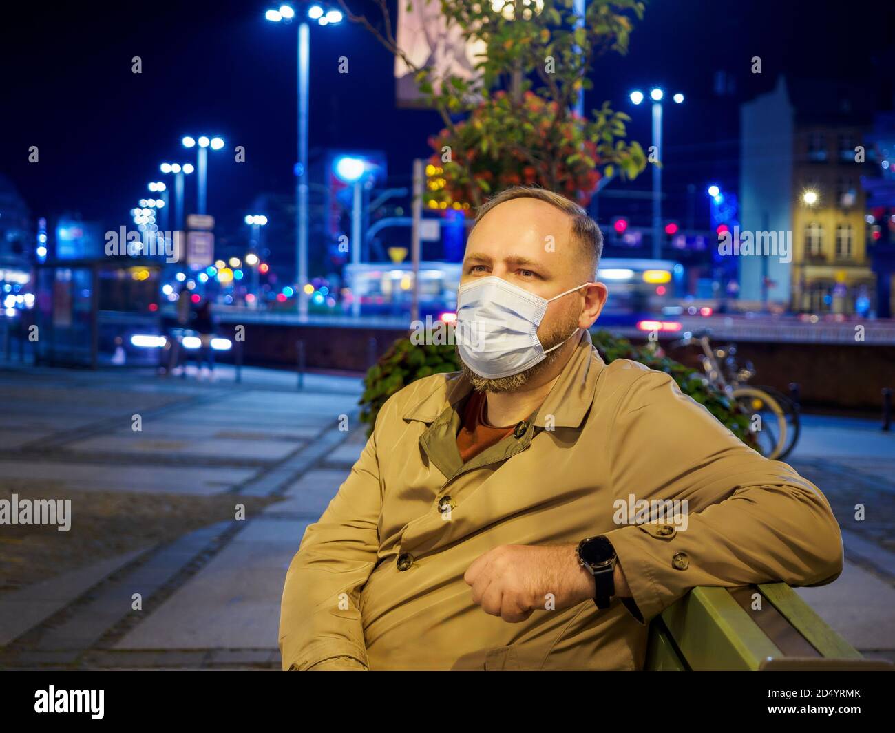 Adult man wearing mask walking in a night european city. Mask is a ...