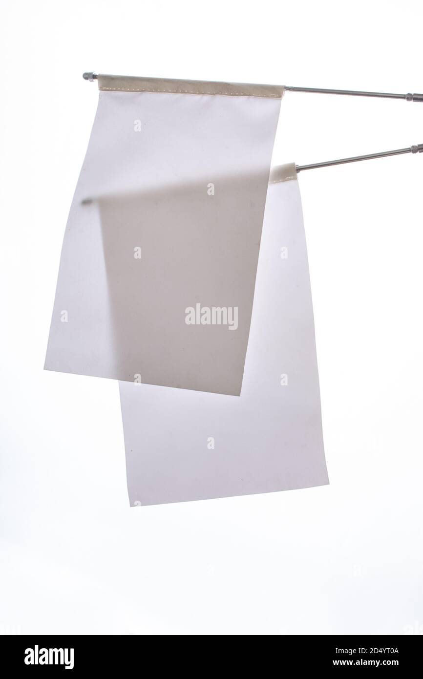Two white flags on a white background in the display Stock Photo - Alamy