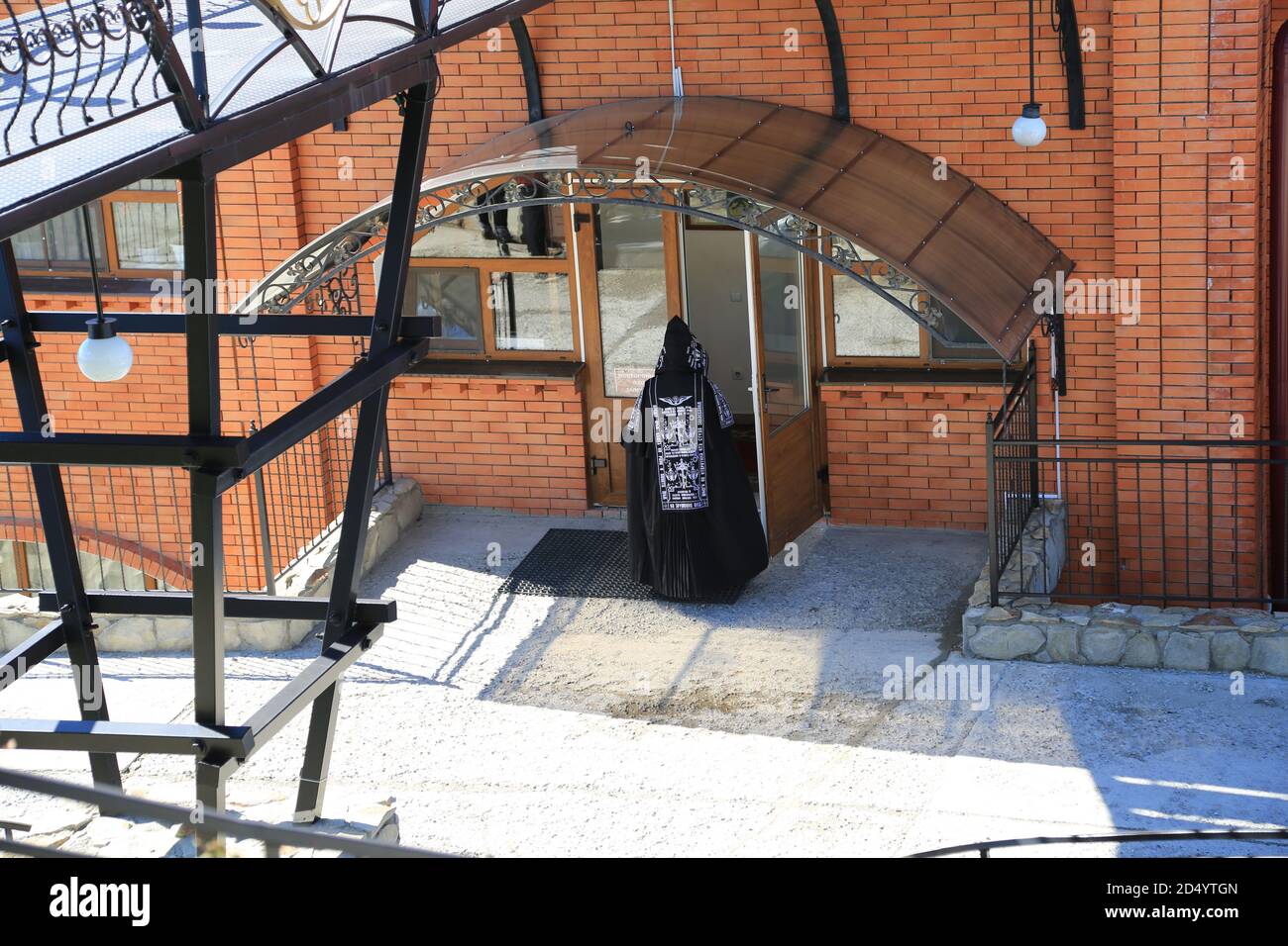 The entrance to the convent. A woman nun at the door of the monastery ...