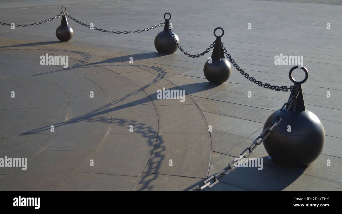 Iron balls joined by chain Stock Photo - Alamy