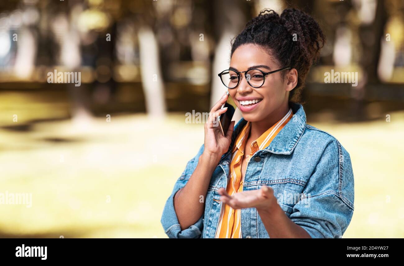 Happy African American Woman Making Phone Call Walking Outdoors Stock ...