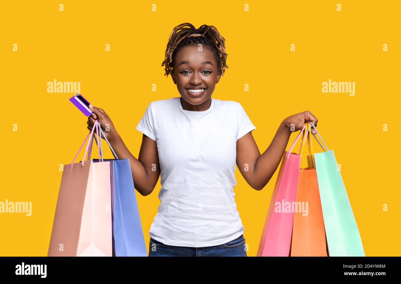 Happy black lady with shopping bags and credit card Stock Photo - Alamy