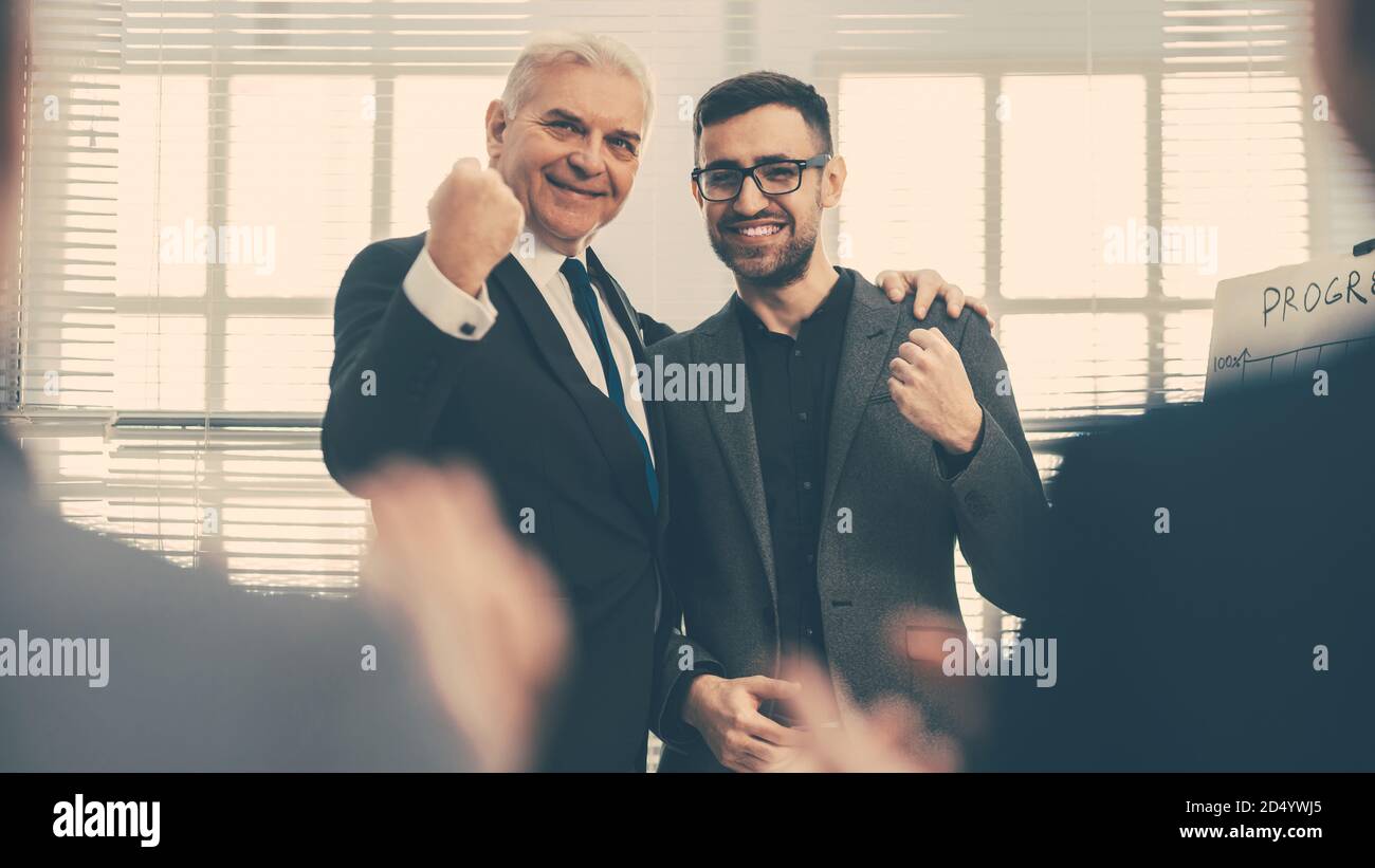 project Manager and best employee standing together Stock Photo - Alamy