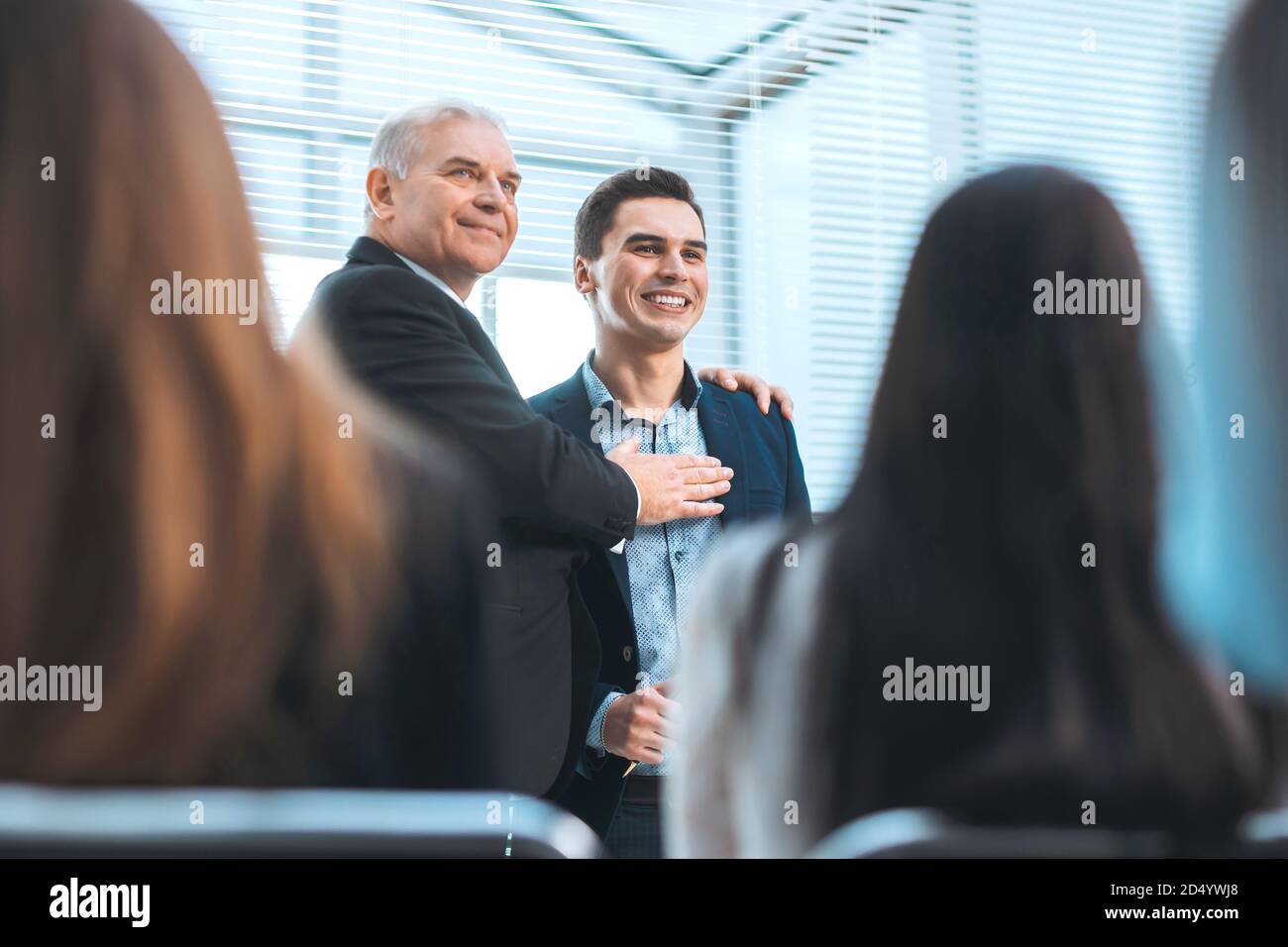 project Manager and best employee standing together Stock Photo - Alamy