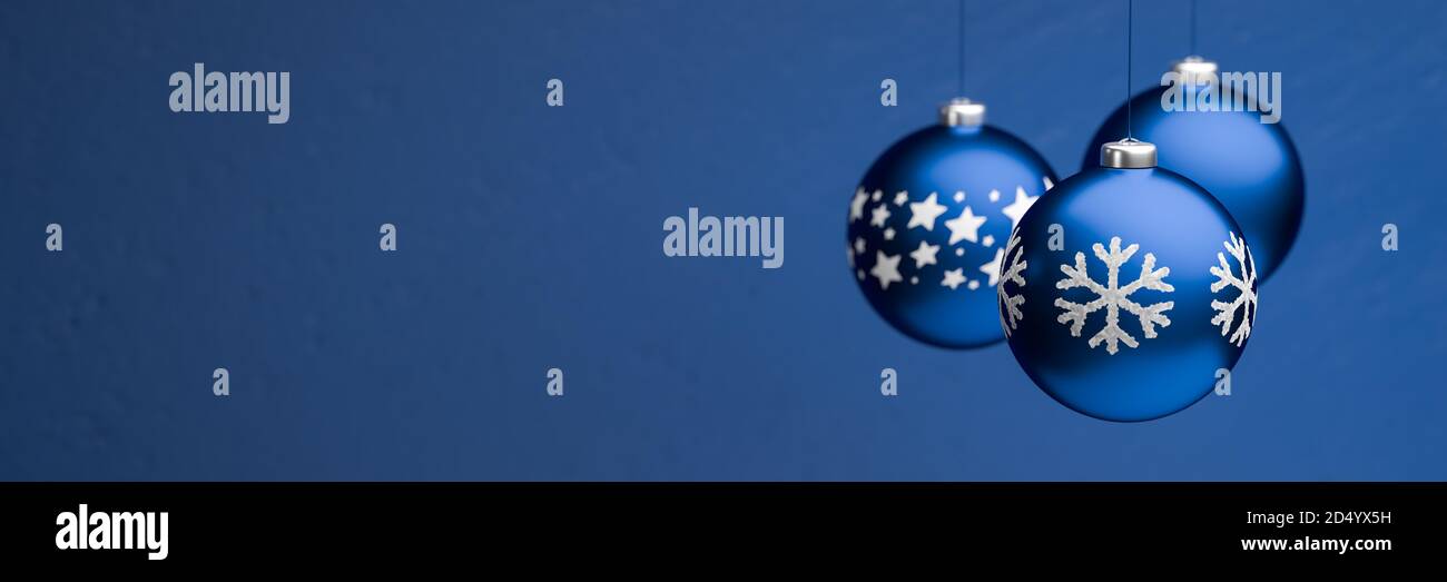Classic blue christmas baubles with different design hanging in front ...