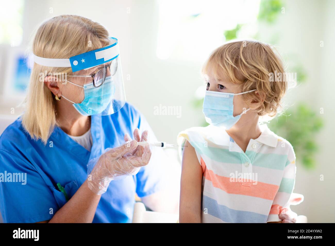Coronavirus vaccination. Covid-19 vaccine. Doctor vaccinating child ...
