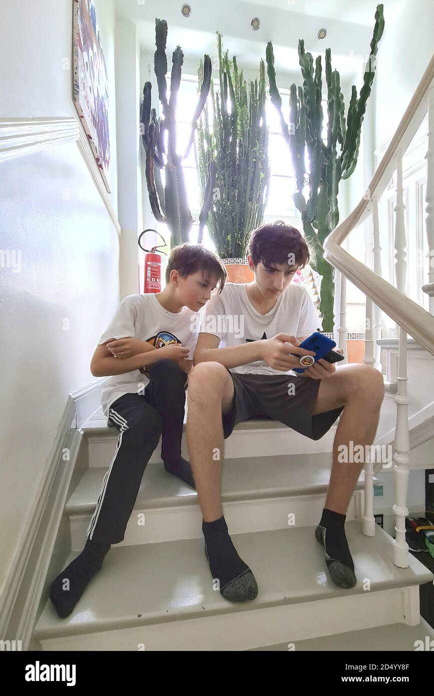 Two people sitting on stairs hi-res stock photography and images - Alamy