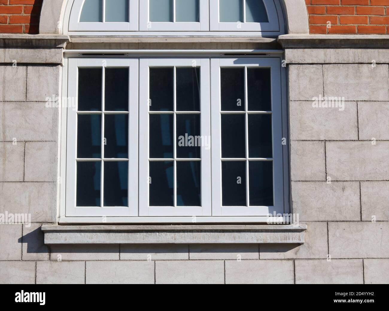 Window of old English building set in traditional blocks and brickwork ...