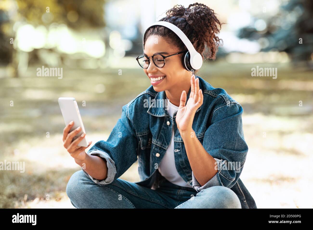 African Lady Waving Hello To Smartphone Making Video Call Outdoors ...