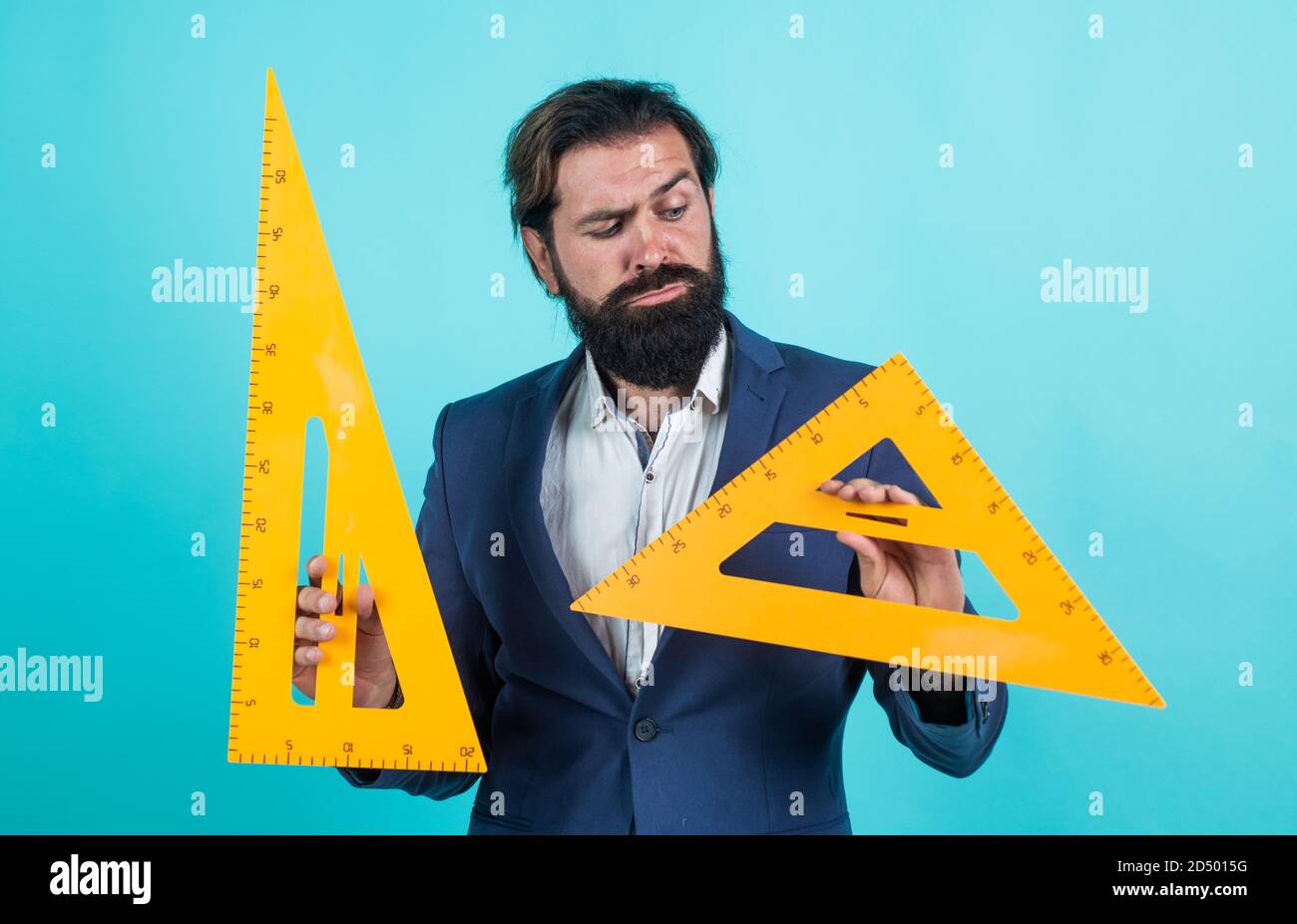 mature bearded man in business suit hold math triangle ruler, graphics ...