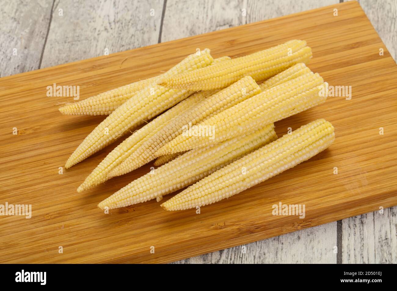 Raw baby corn over the wooden board Stock Photo - Alamy