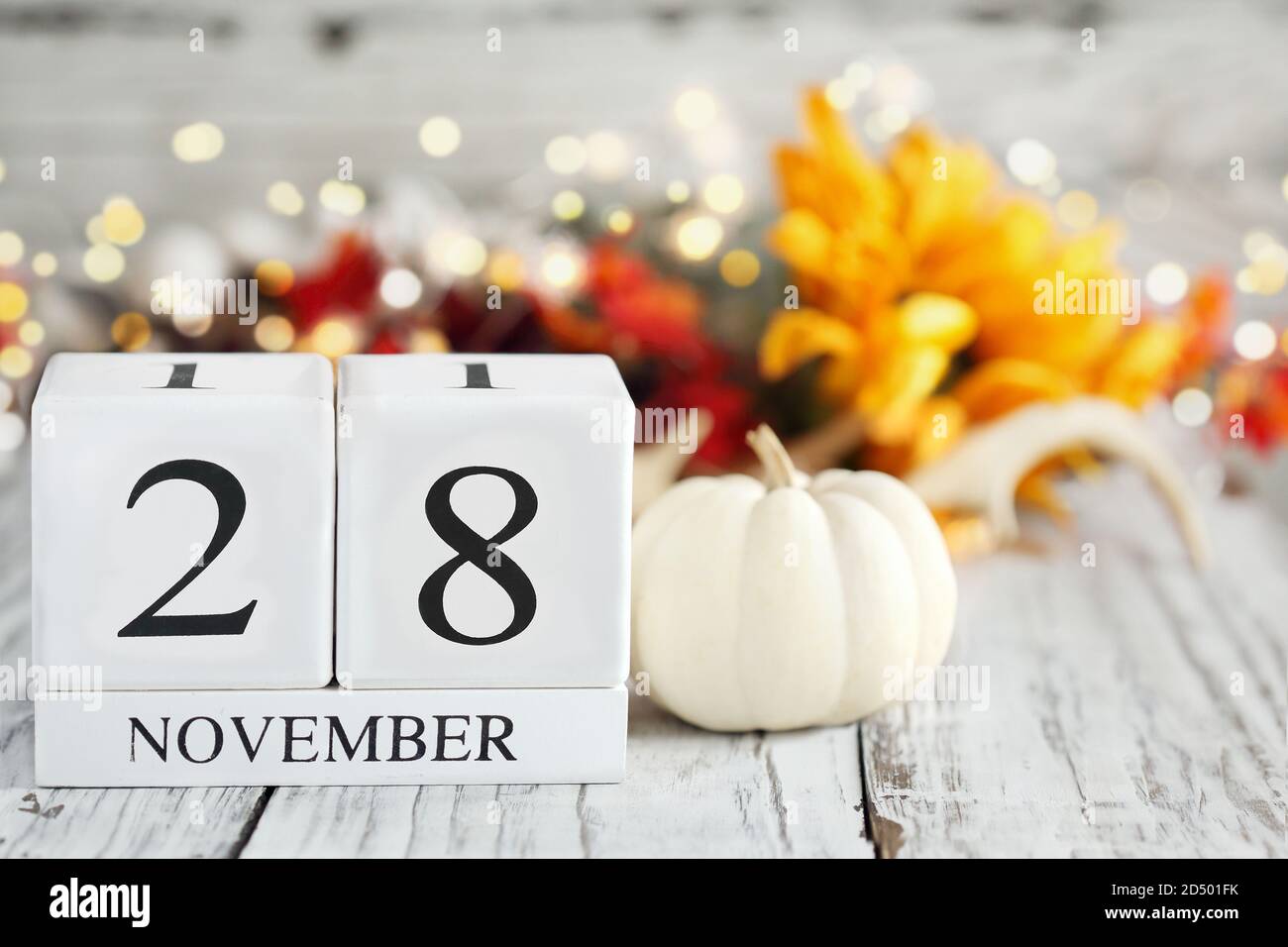 White wood calendar blocks with the date November 28th and autumn ...