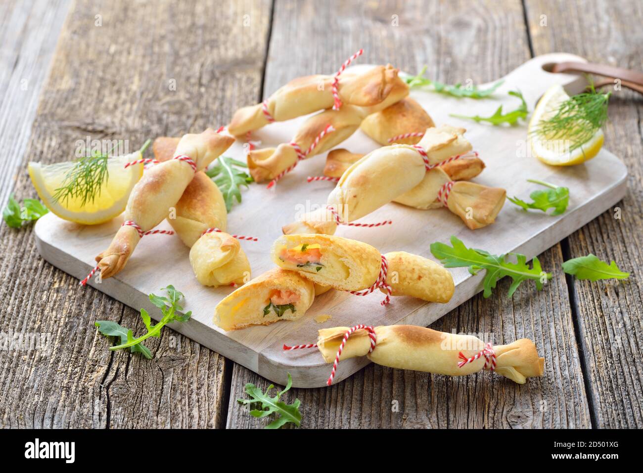 Baked funny pastry sweets made of dough stuffed with smoked salmon ...