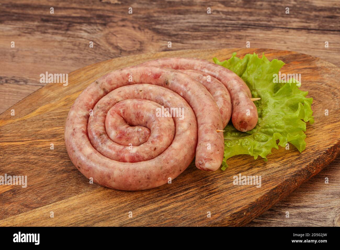 Raw pork sausage ring for grill Stock Photo - Alamy