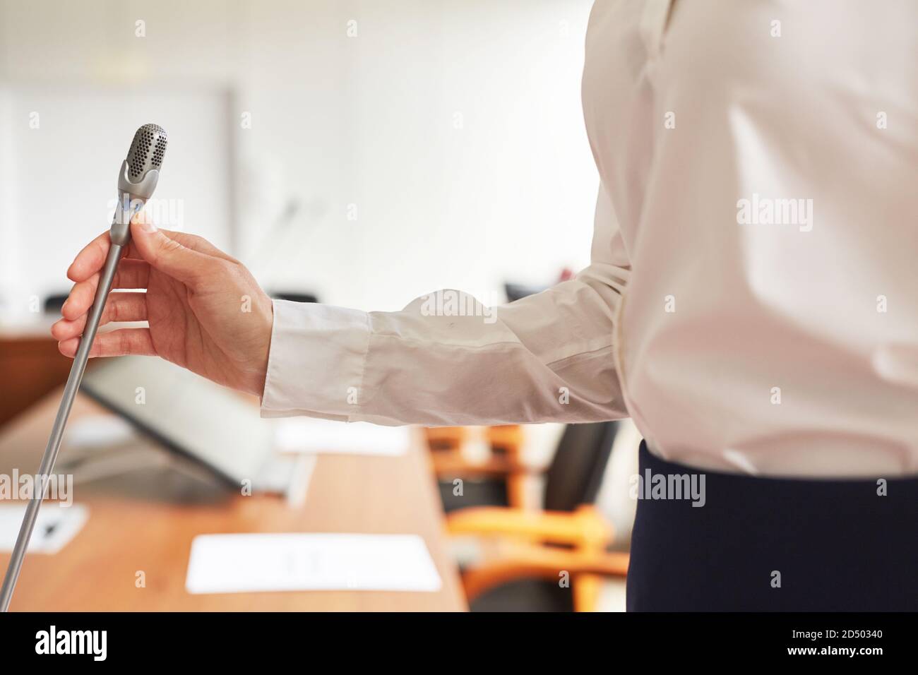 Close up of elegant female secretary adjusting microphone while ...
