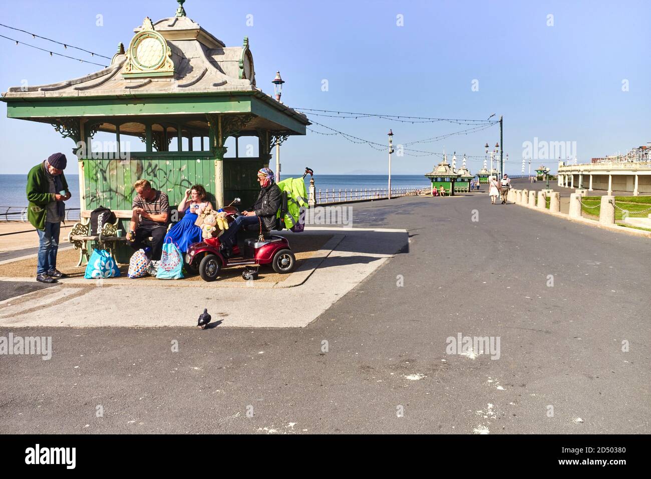 Drinkers and homeless people sitting in a beach shelter near north pier ...