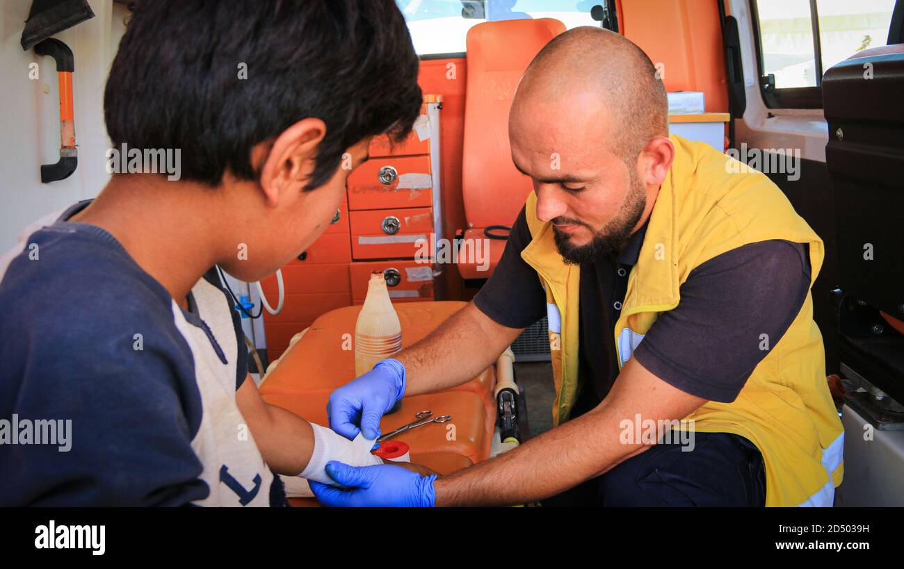 nurse embraces a child and treating him inside the ambulance Stock ...