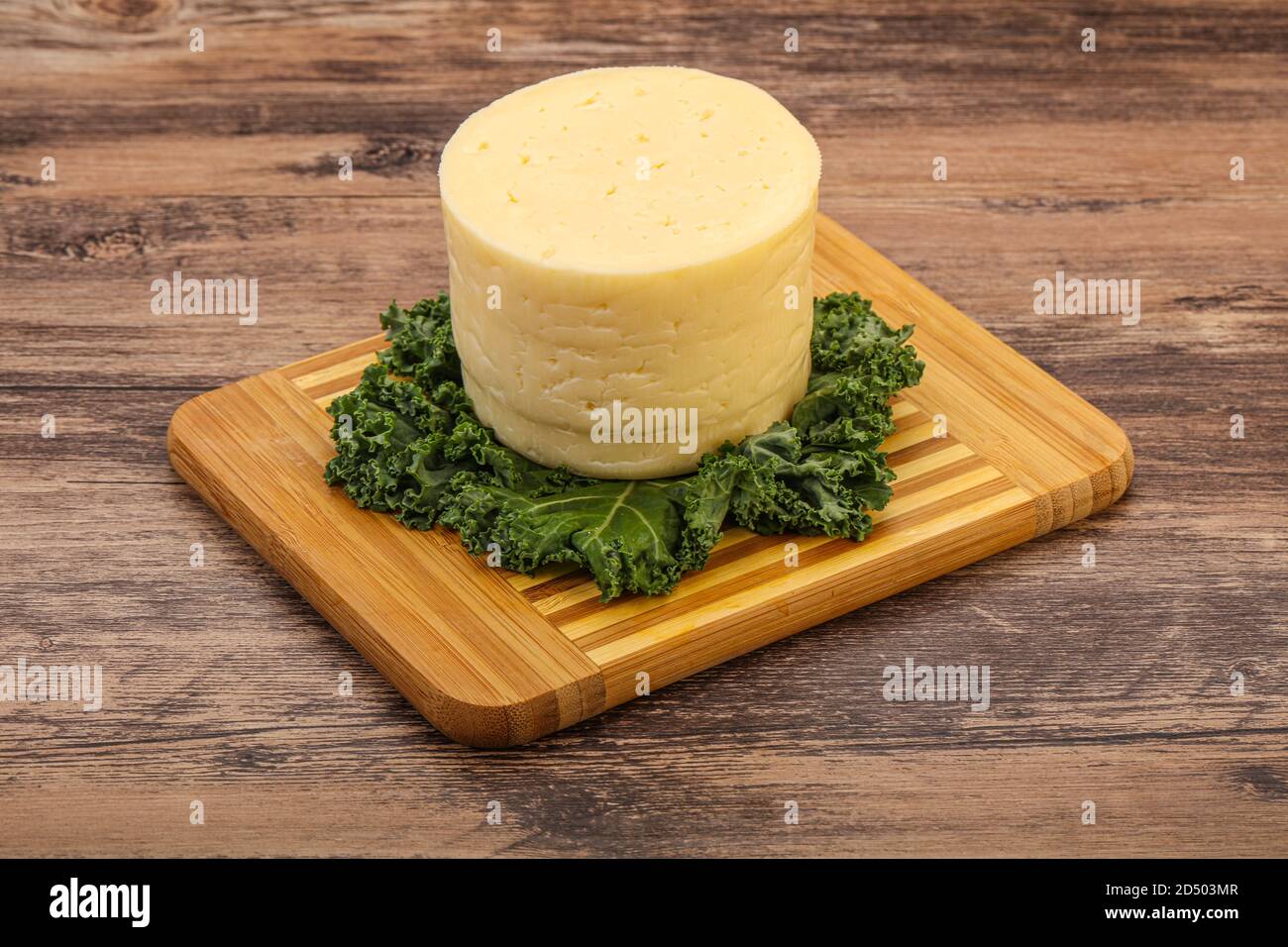 Yellow round dairy soft cheese piece Stock Photo - Alamy
