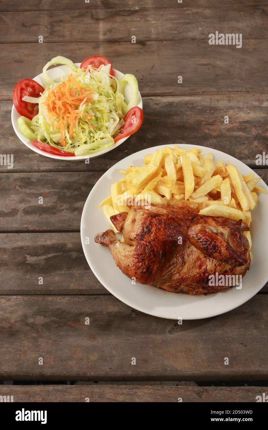 Peruvian food called Pollo a la brasa with salad and french fries Stock ...