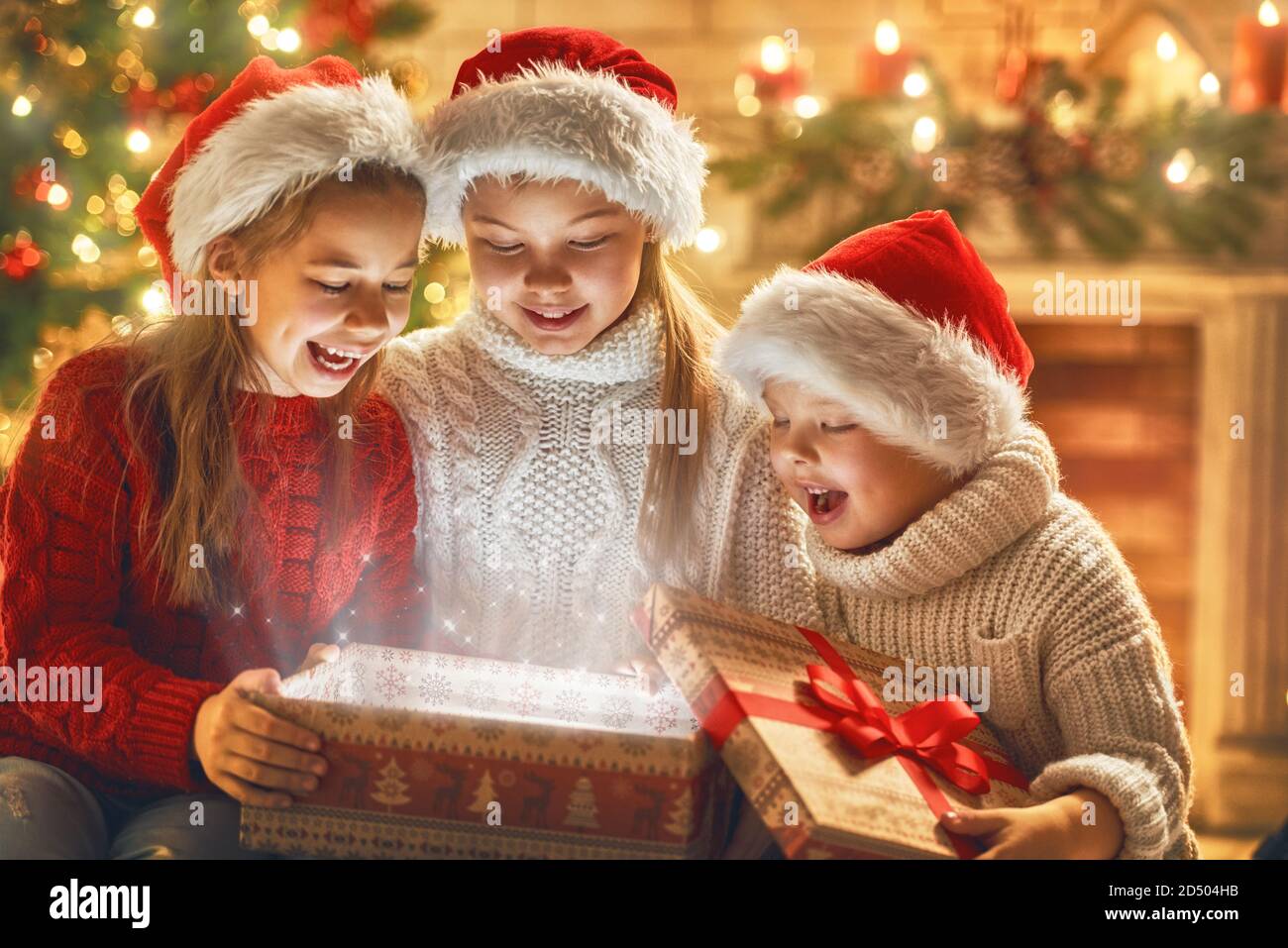 Merry Christmas and Happy Holiday! Cute little children with magic ...