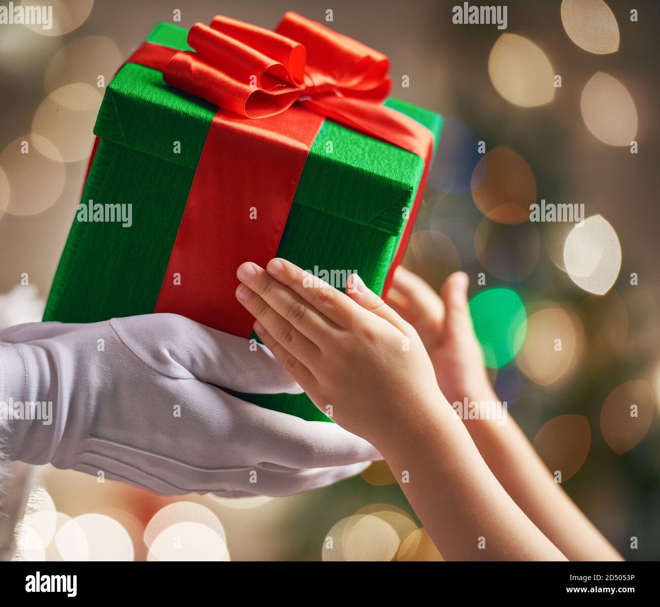 Santa Claus is giving a Christmas gift to child Stock Photo - Alamy