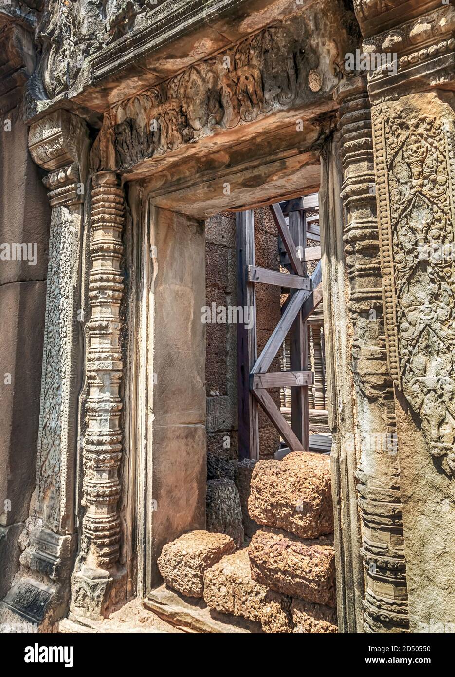 Khmer architecture Detailed carvings on the pink limestone walls of ...