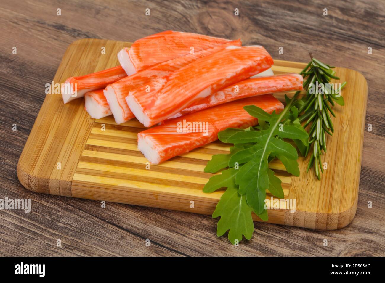 Crab stick surimi over wooden board Stock Photo - Alamy