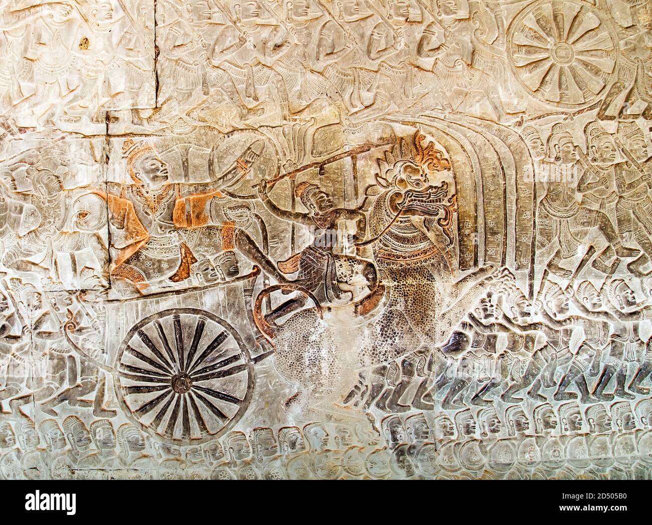 relief carving of gods fighting demons. Inner wall of the temple of ...