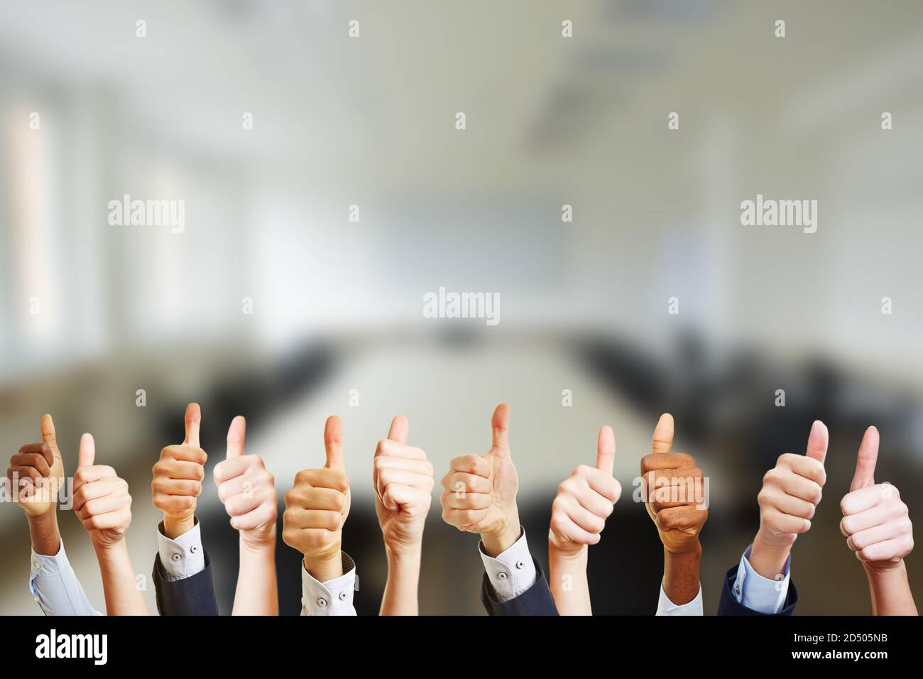 Business people hold thumbs up at work Stock Photo - Alamy