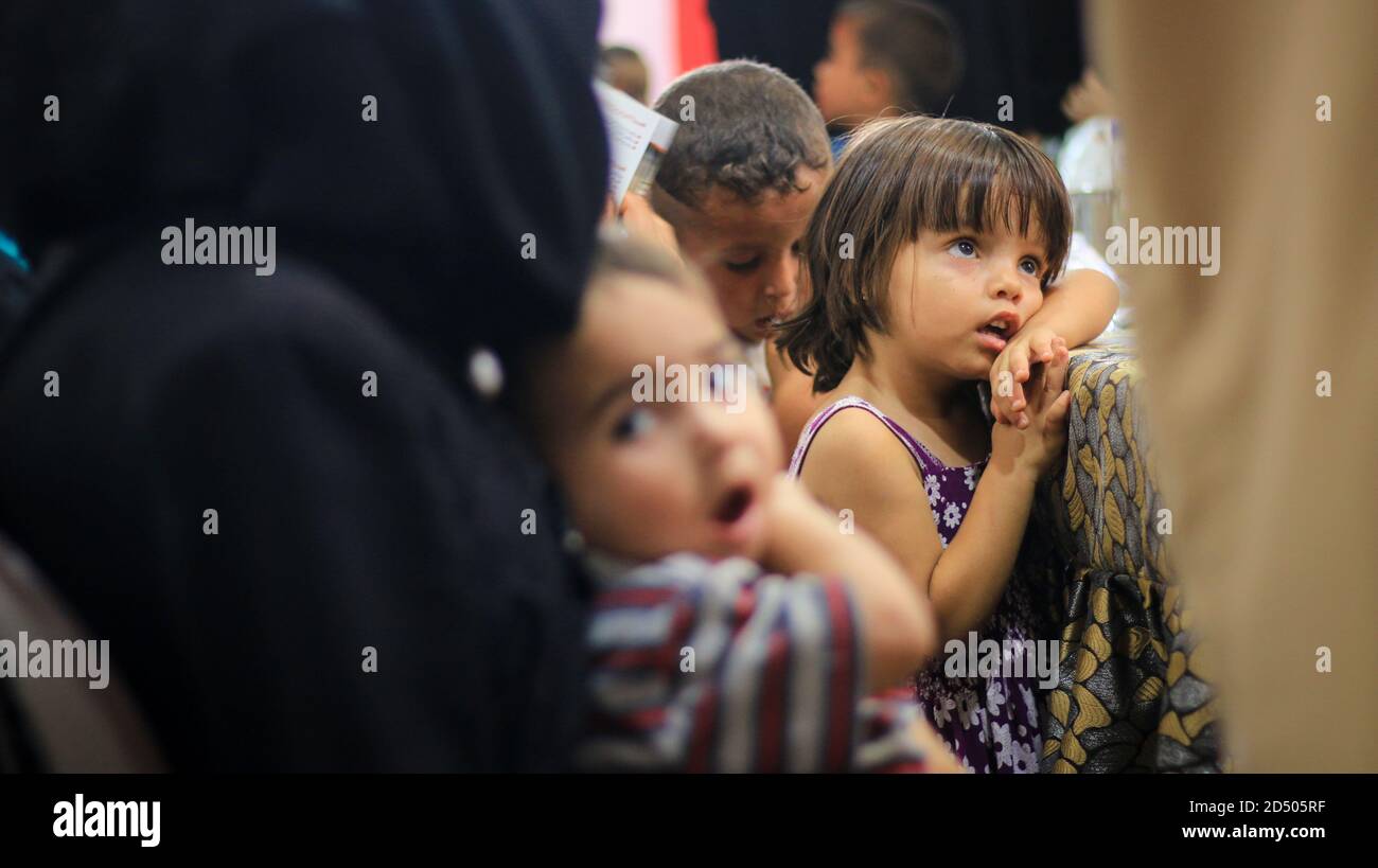 tired child, a sad child's face, sick children waiting to enter the ...