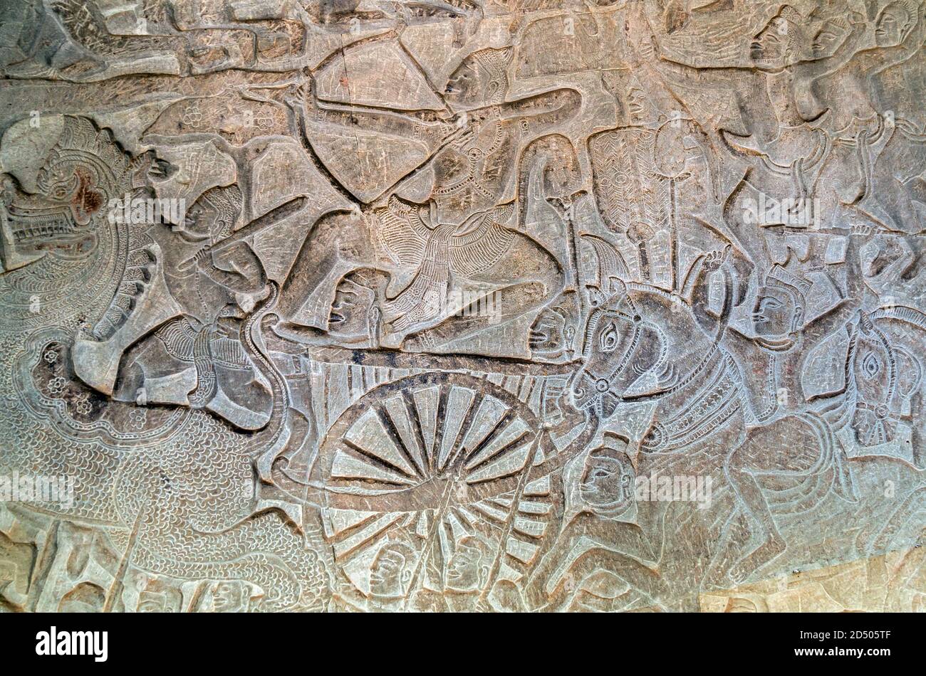 Khmer relief carving of gods fighting demons. Inner wall of the temple ...