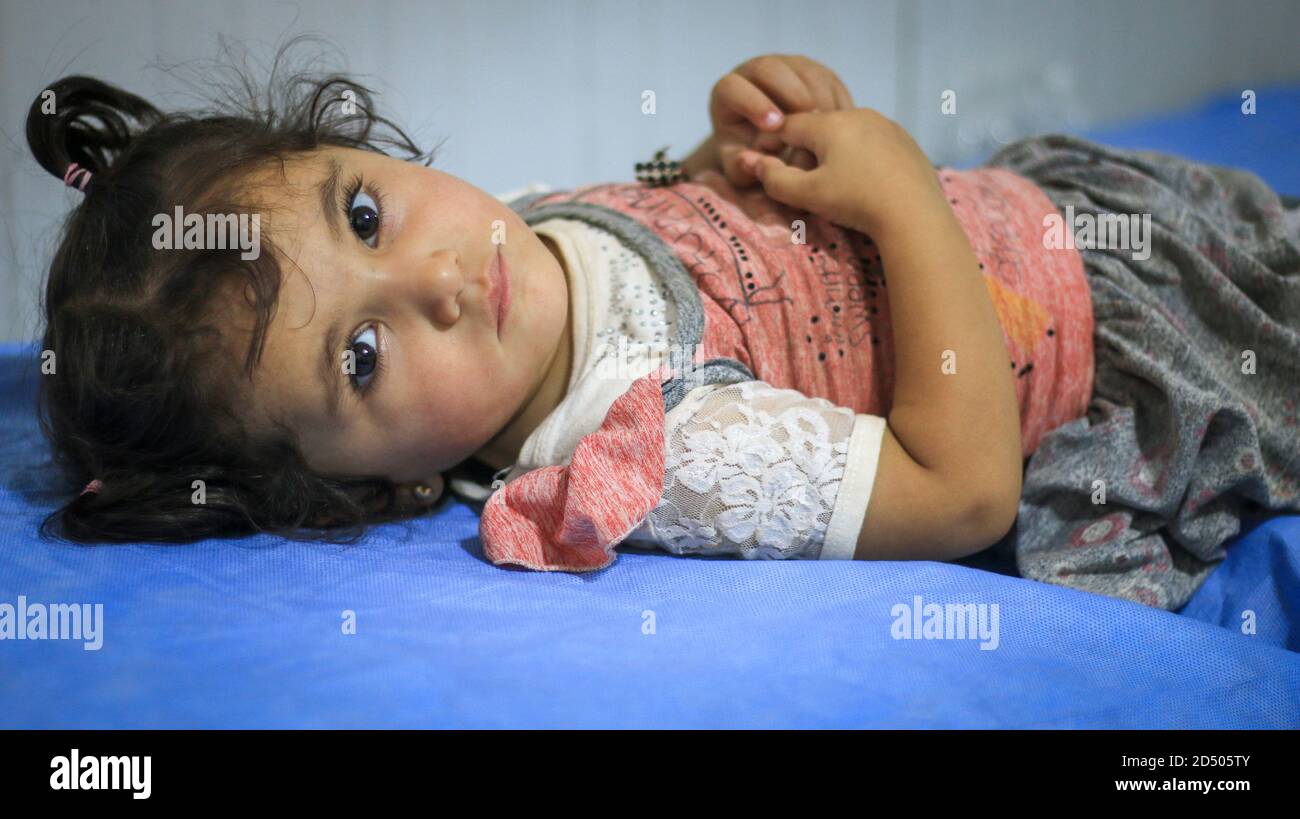 tired child, a sad child's face, sick children waiting to enter the ...