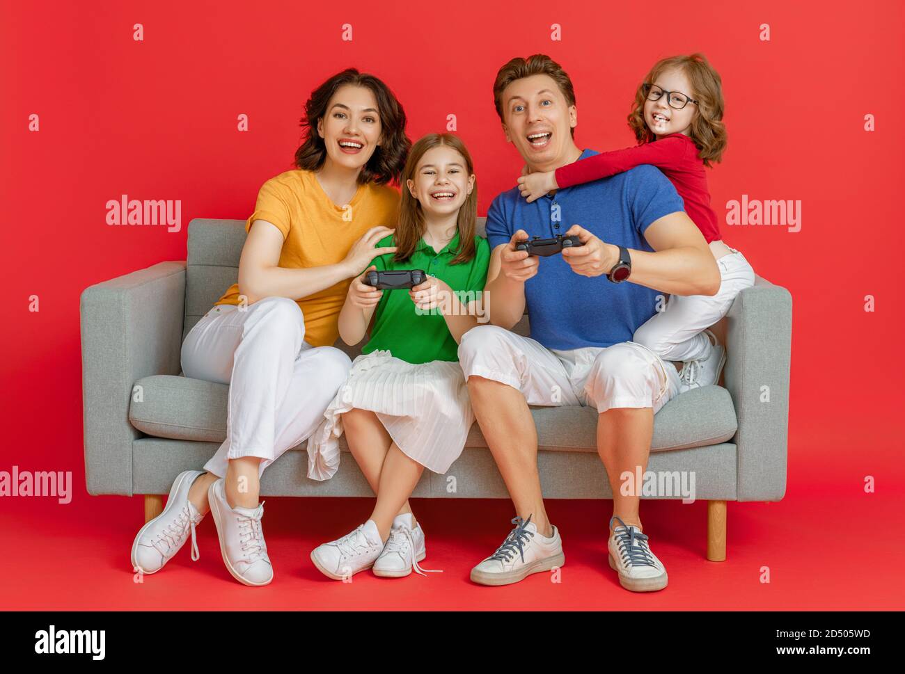 Happy family together. Mother, father and their children girls playing ...