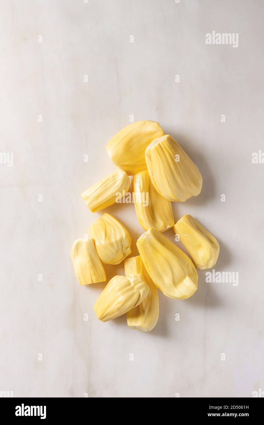 Ripe raw peeled jackfruit over white marble background. Flat lay, space ...