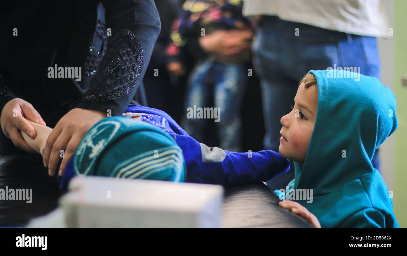 tired child, a sad child's face, sick children waiting to enter the ...