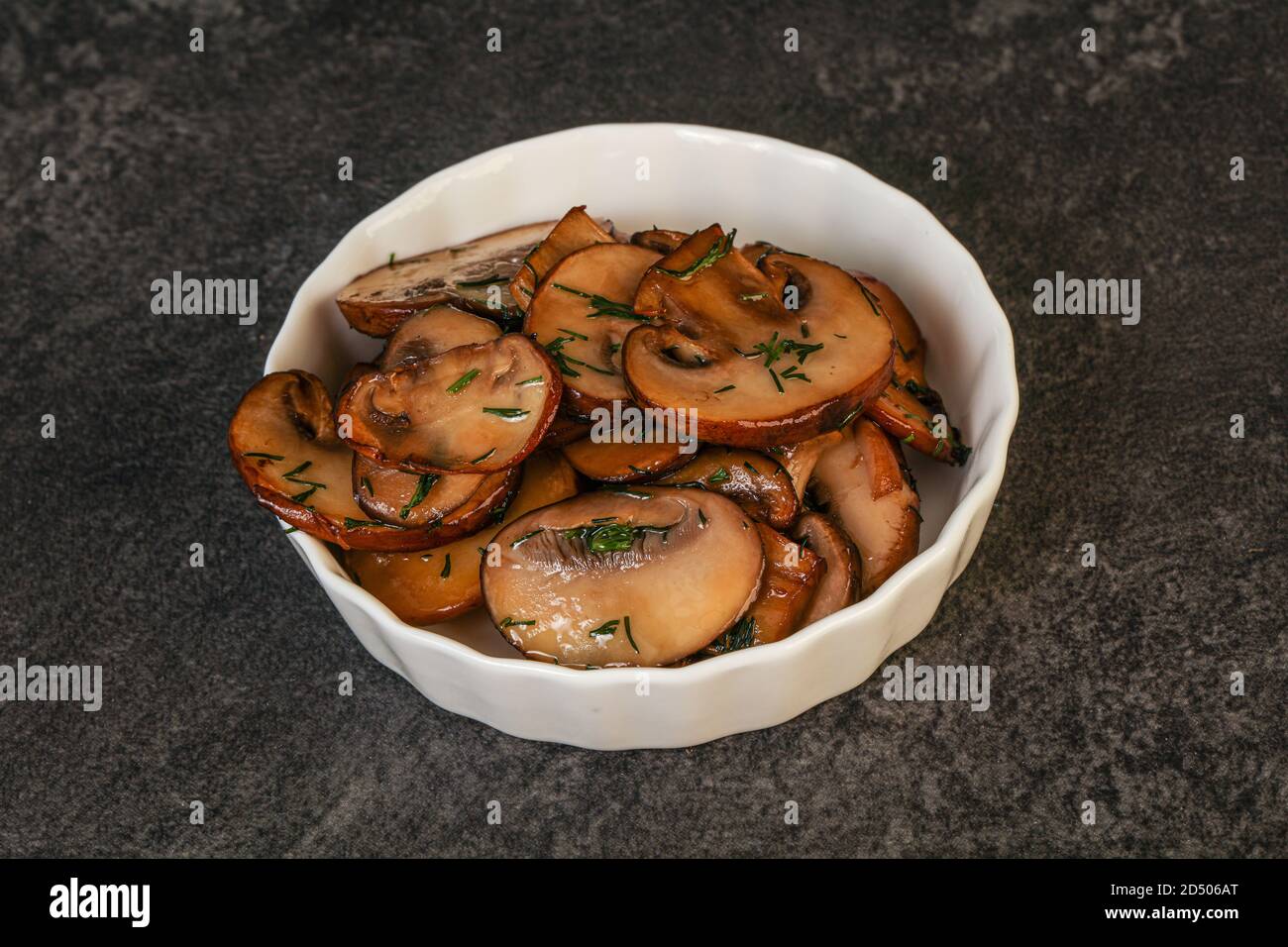 Roasted champignon with herbs and spices in the bowl Stock Photo - Alamy